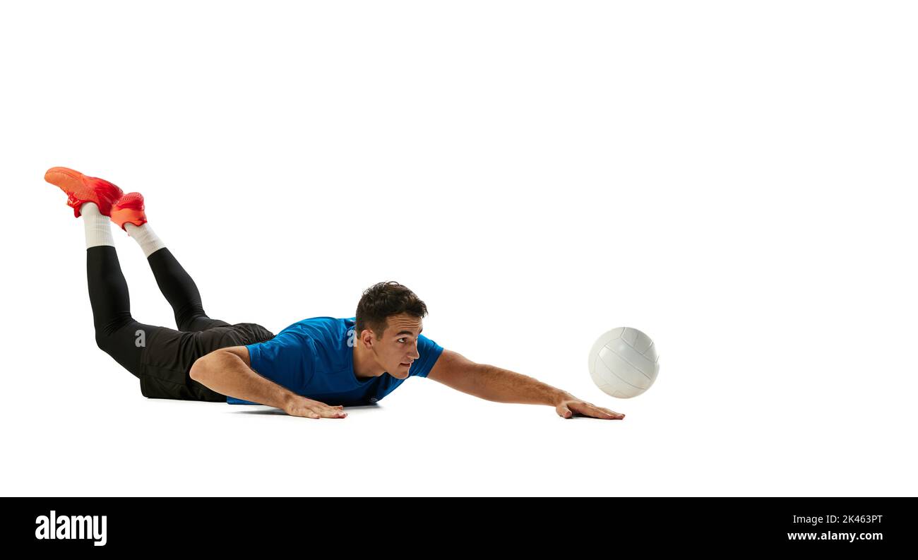 Studio shot of young man, volleyball player playing volleyball isolated ...