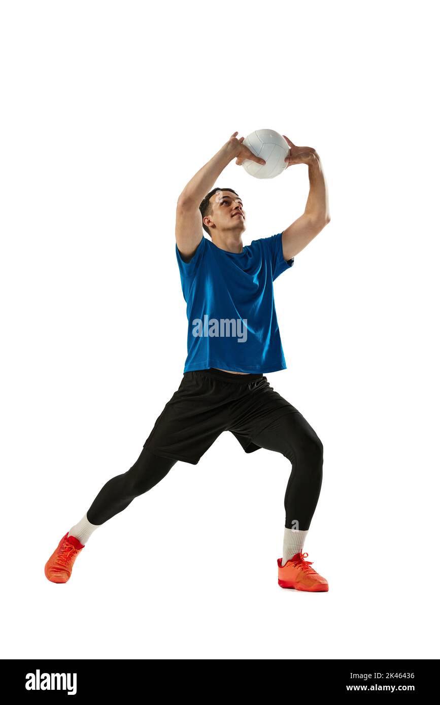 Dynamic portrait of male volleyball player training with ball isolated ...