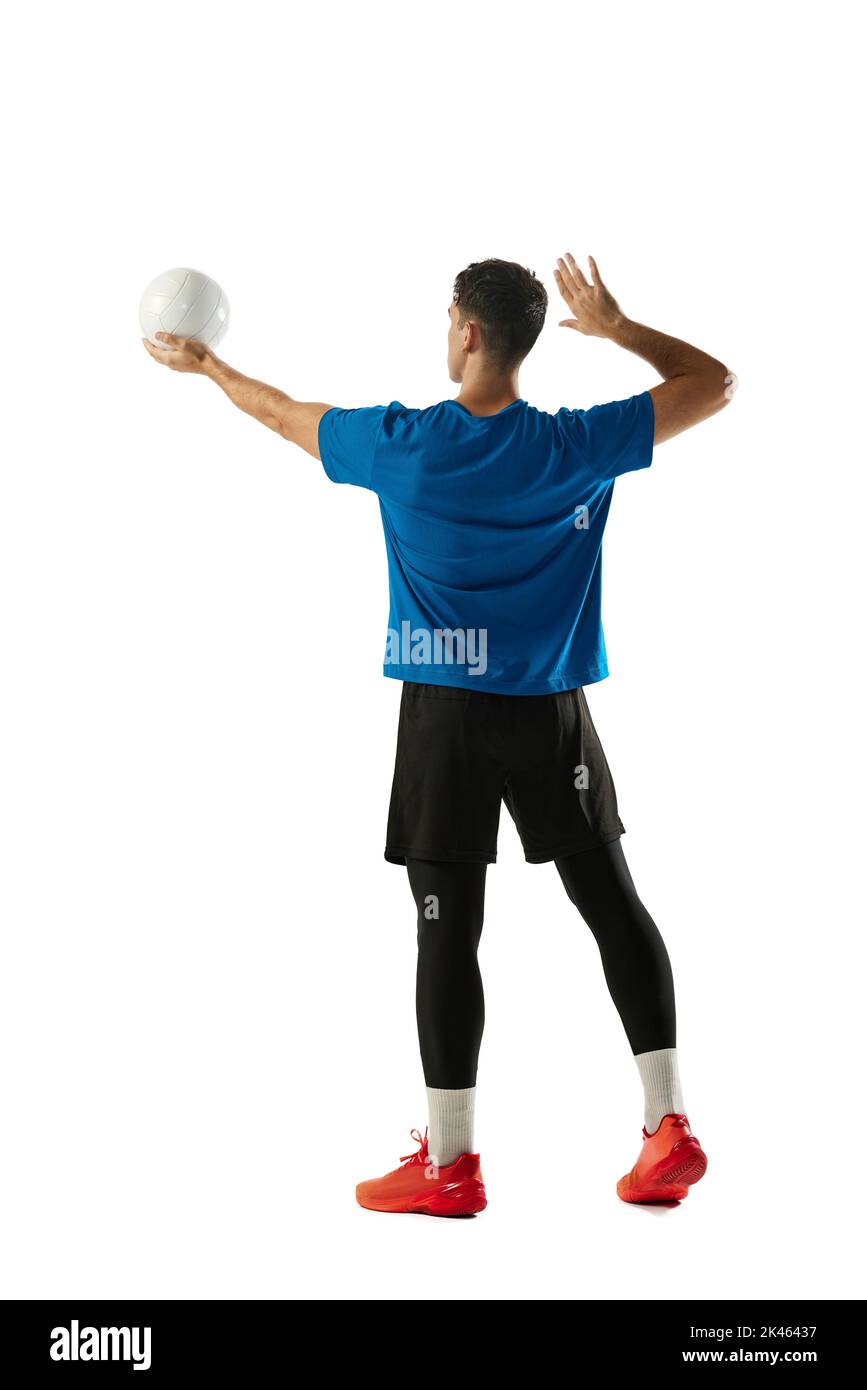 Back view of professional volleyball player in sports uniform training ...
