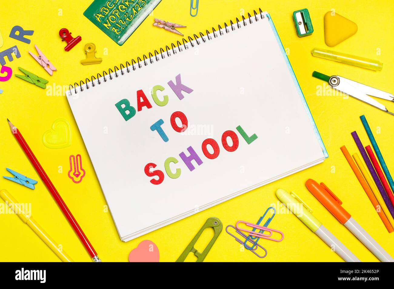 Back to school write in a notebook with colored toy letters and school ...