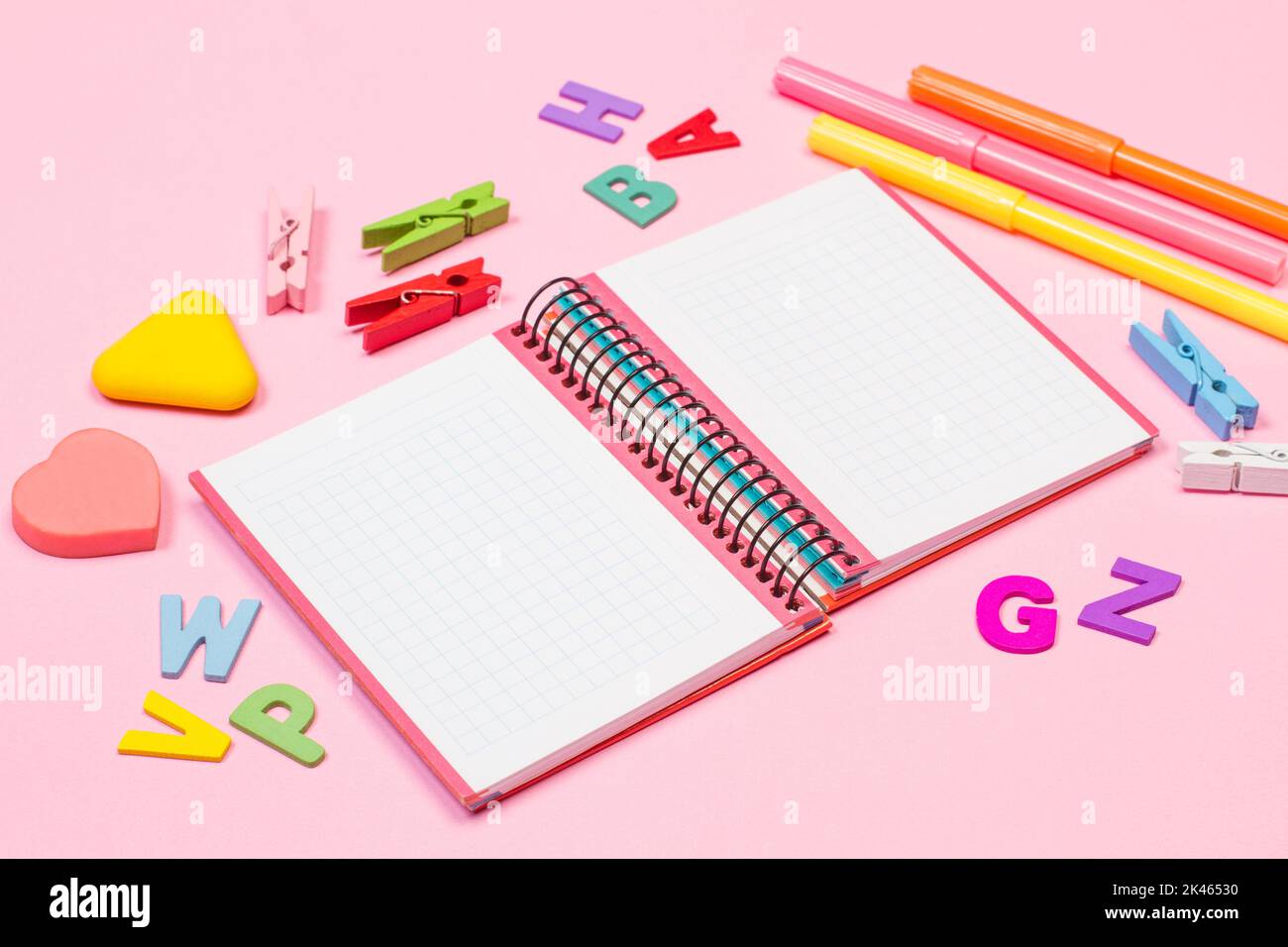 Open graph notebook and school utensils on a pink background Stock ...