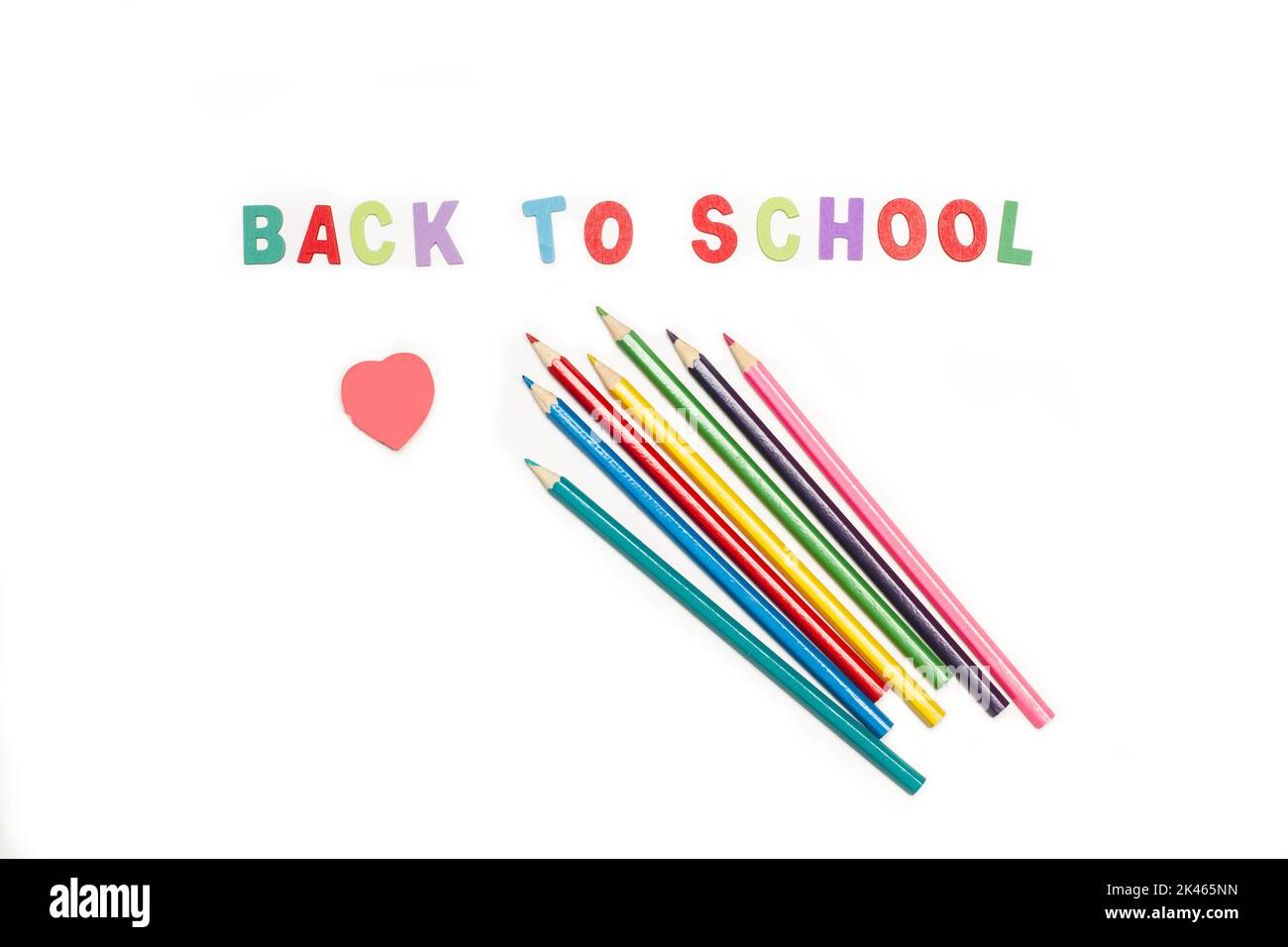 Back to school write with colored wooden letters and colored pencils on ...