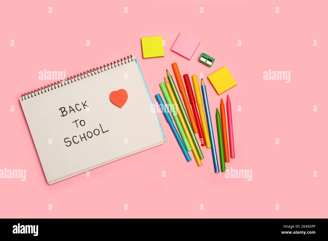 Back to school write in a notebook, colored pencils and markers on a ...