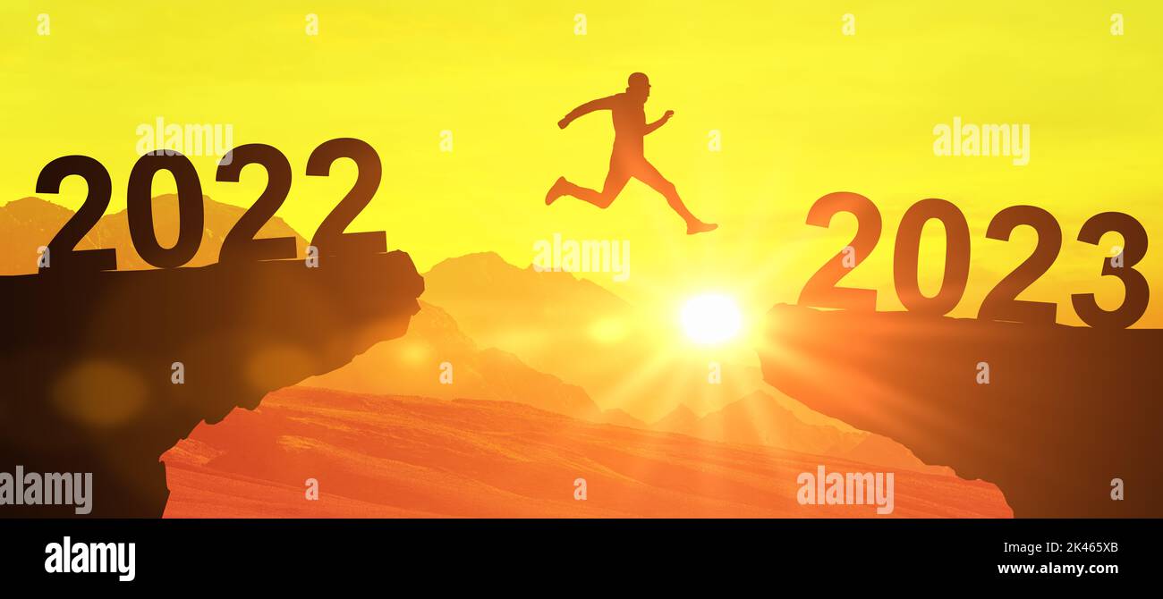 Silhouette man jump between 2022 and 2023 years over sun and through on ...