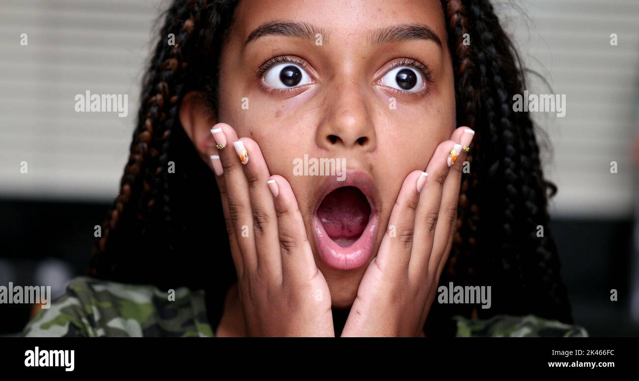Excited child shocking reaction. girl reacts with surprise with open mouth Stock Photo - Alamy