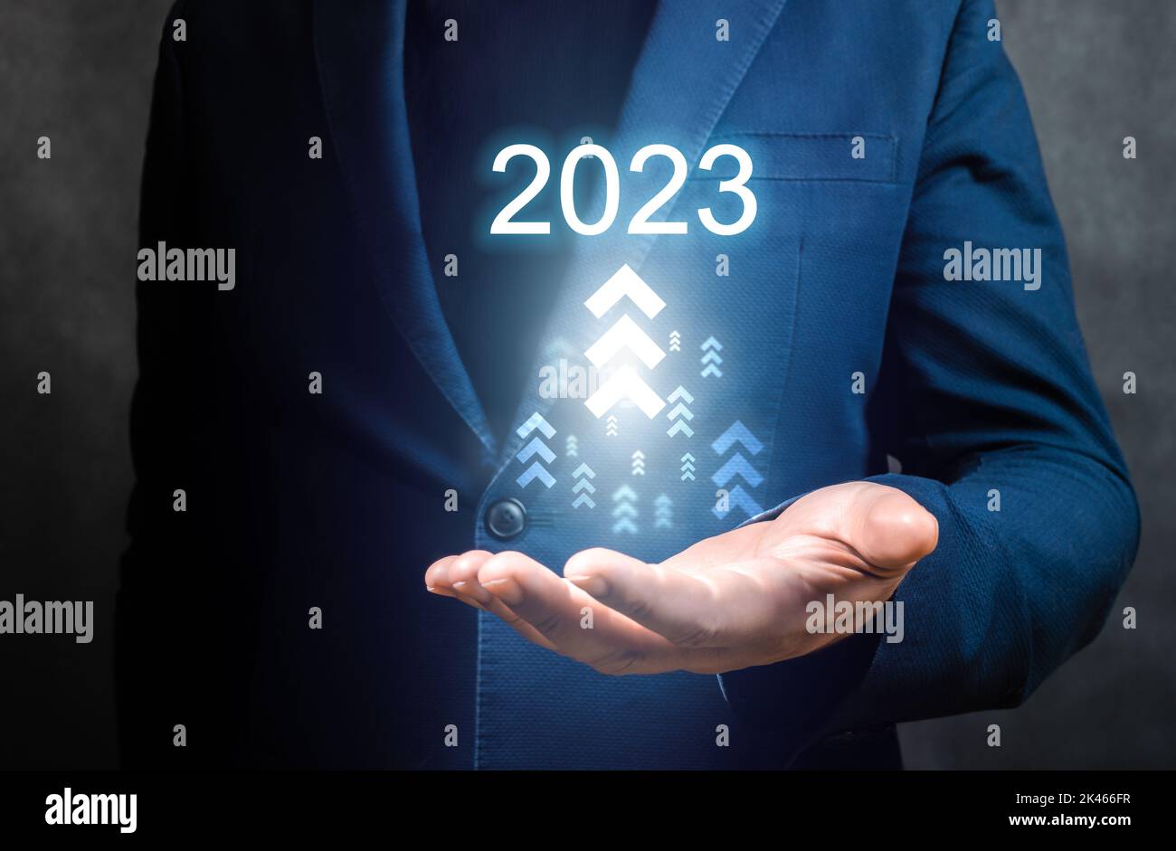 person hold hologram with 2023 up arrows. Business success and ...