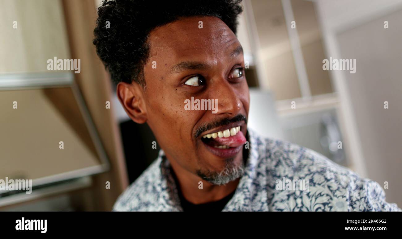 Happy African man grimacing doing funny faces and smiling Stock Photo ...