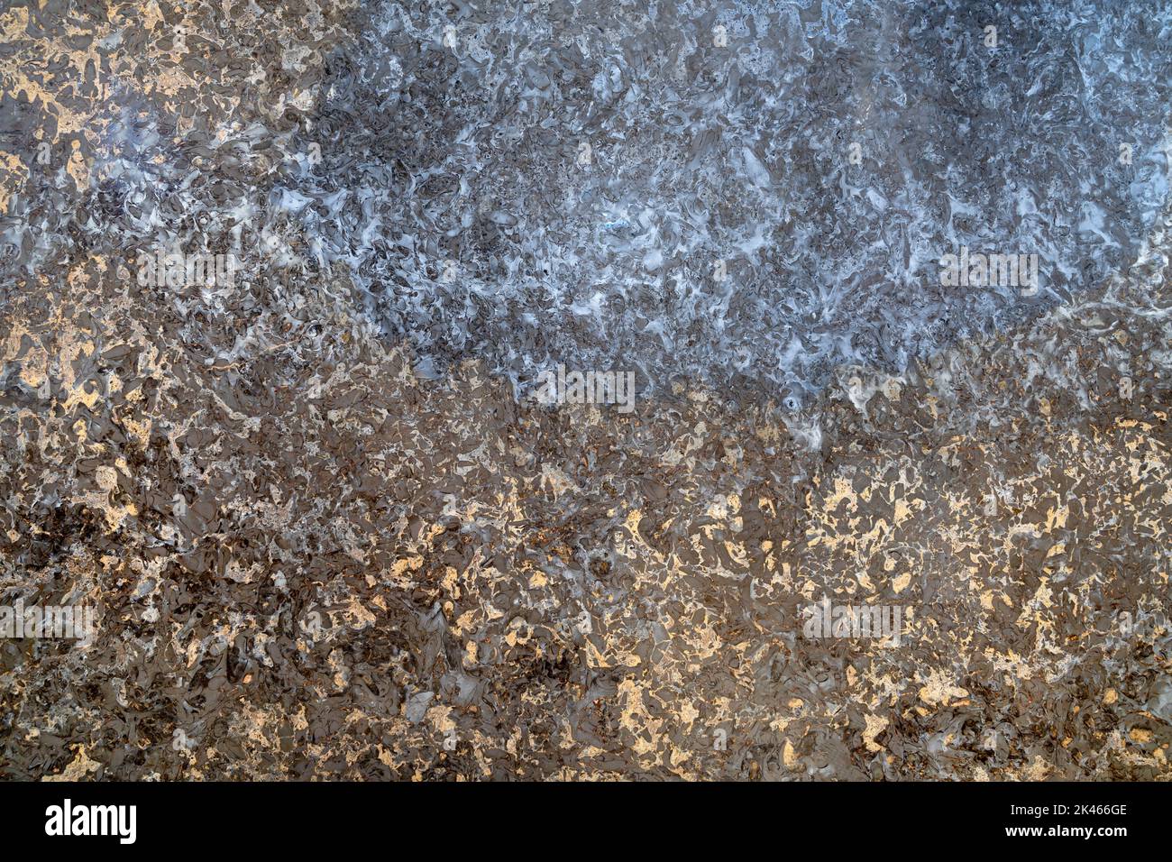 Noble, smoothly ground stone slab with abstract pattern in brown and ...