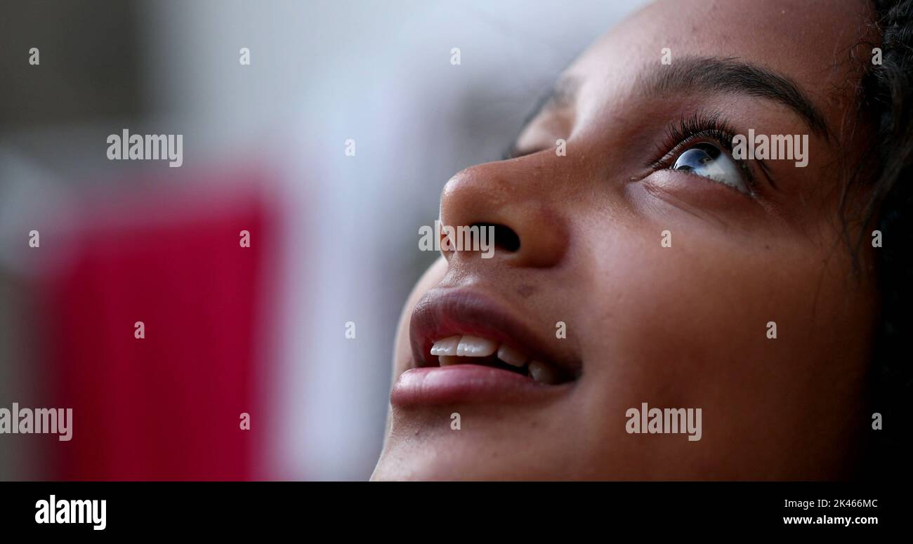 Hispanic black girl child opening eyes to sky smiling face close-up ...