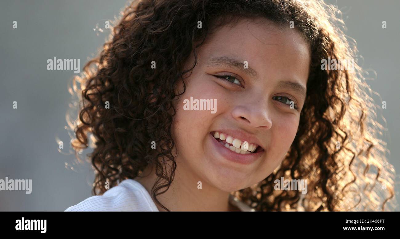 HIspanic little girl child portrait face close-up smiling outside Stock Photo - Alamy
