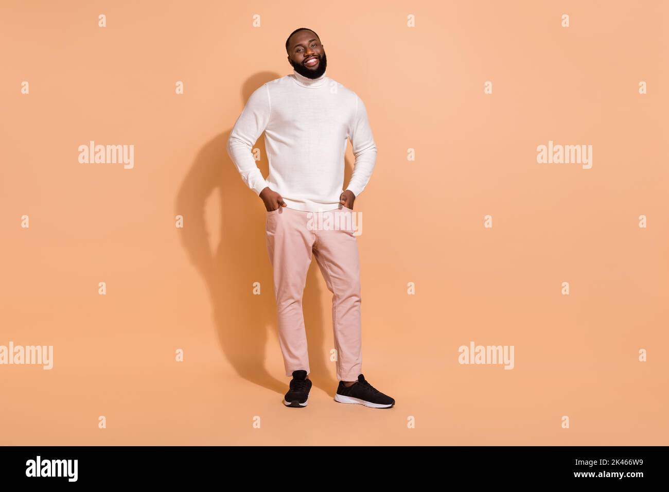 Photo of handsome charming young guy dressed white pullover hands arms ...