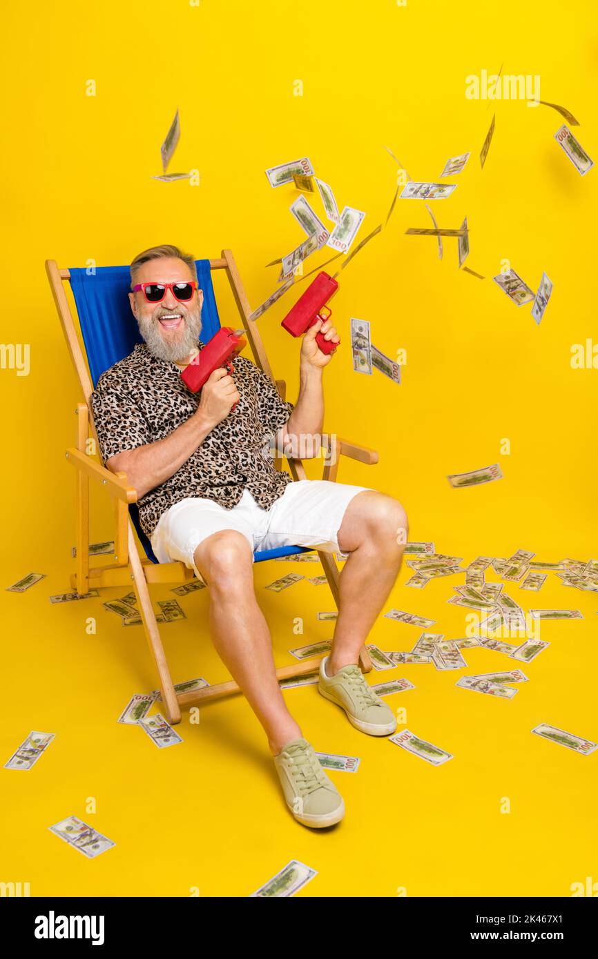 Full body vertical photo of funky excited man money gun shooting bills ...