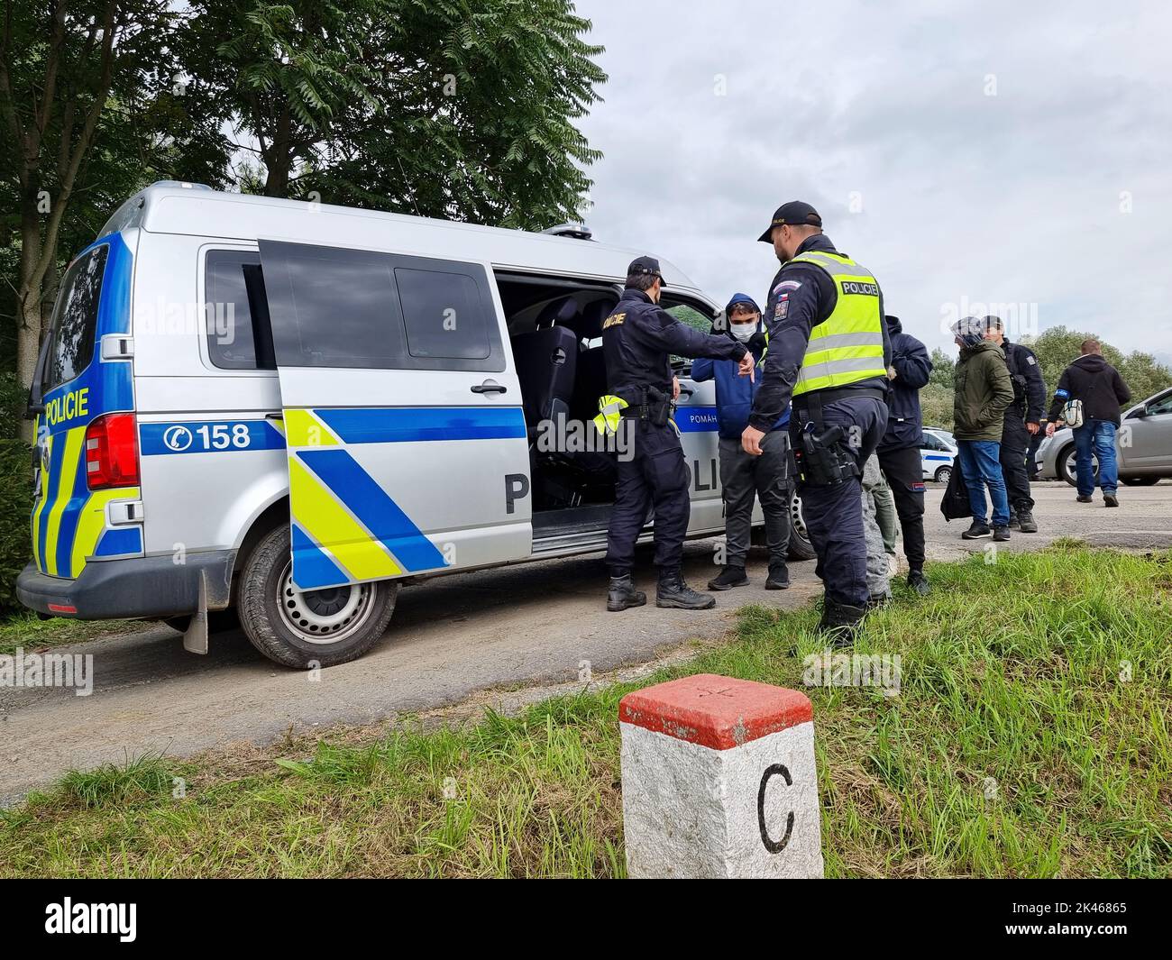 Czech police officers detain group of migrants at the border crossing ...