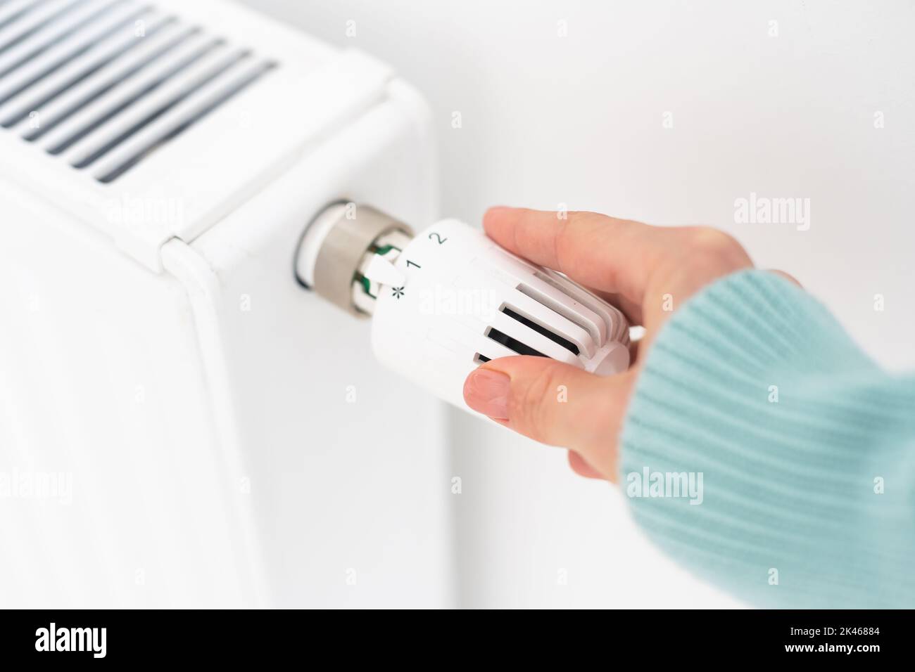 Woman's hand on a white radiator. Heating season. Energy crisis. Cold ...