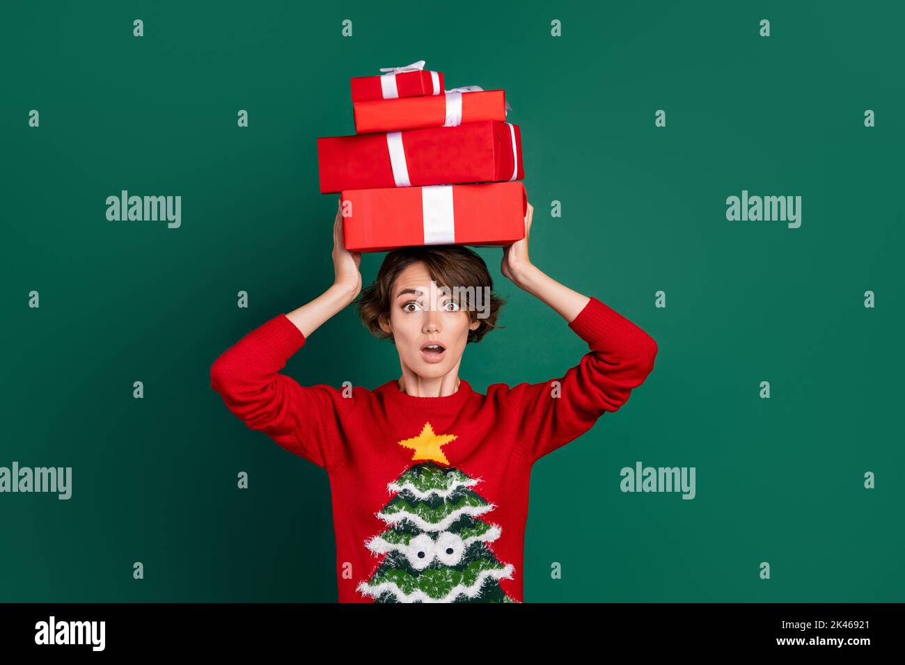 Photo of funny excited lady wear red sweater holding head bow packages ...