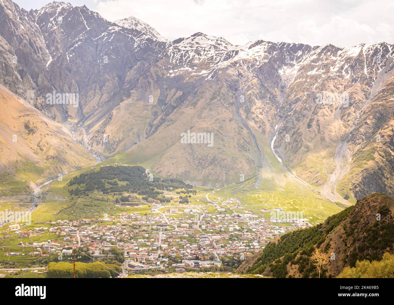 Stepantsminda village aerial view with Caucasus mountains in the ...