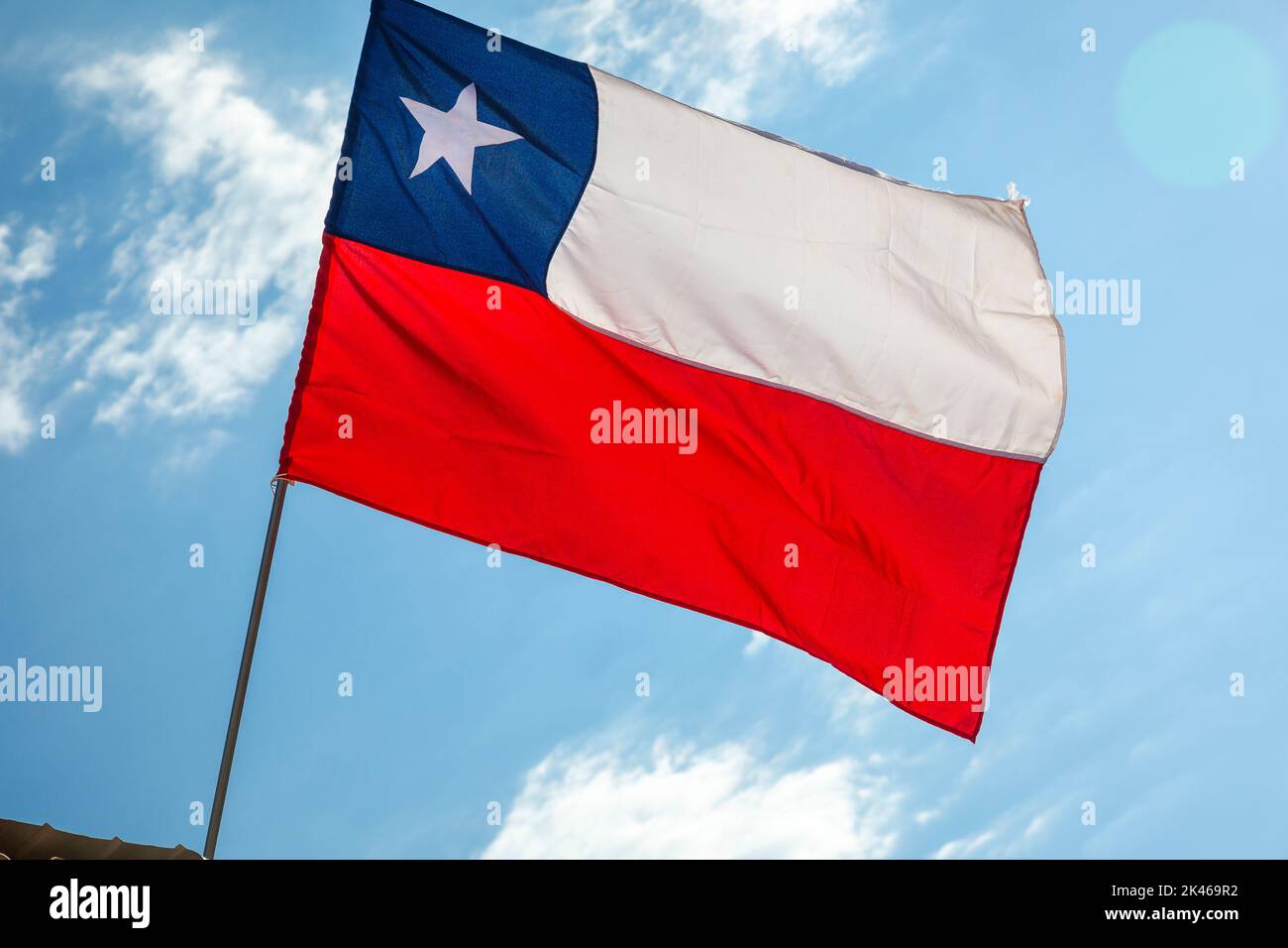 National flag of Chile blowing on blue sky in Santiago, South America ...