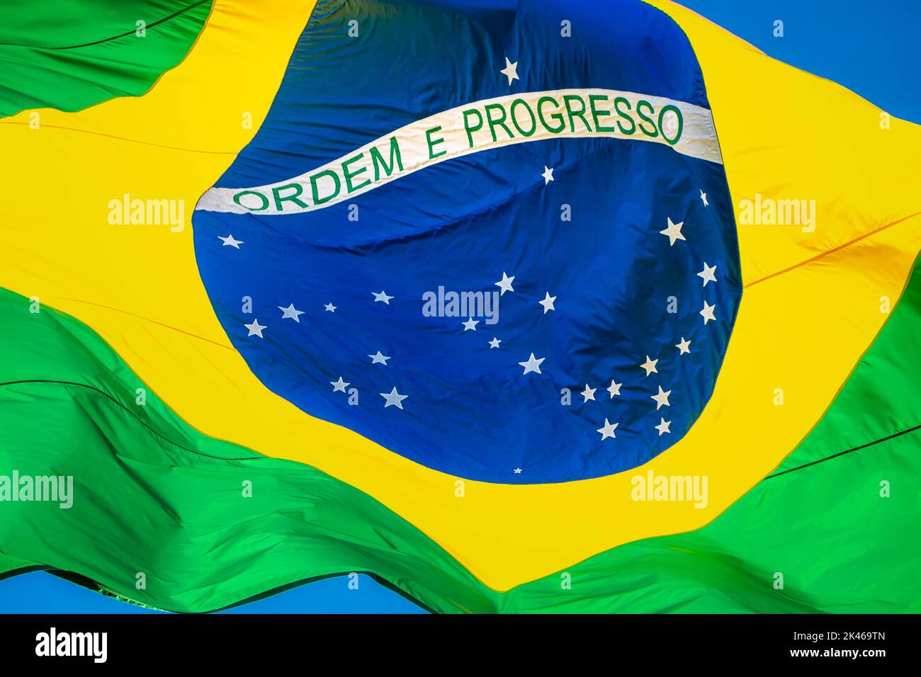 National flag of Brazil blowing on blue sky in Brasilia, South America ...