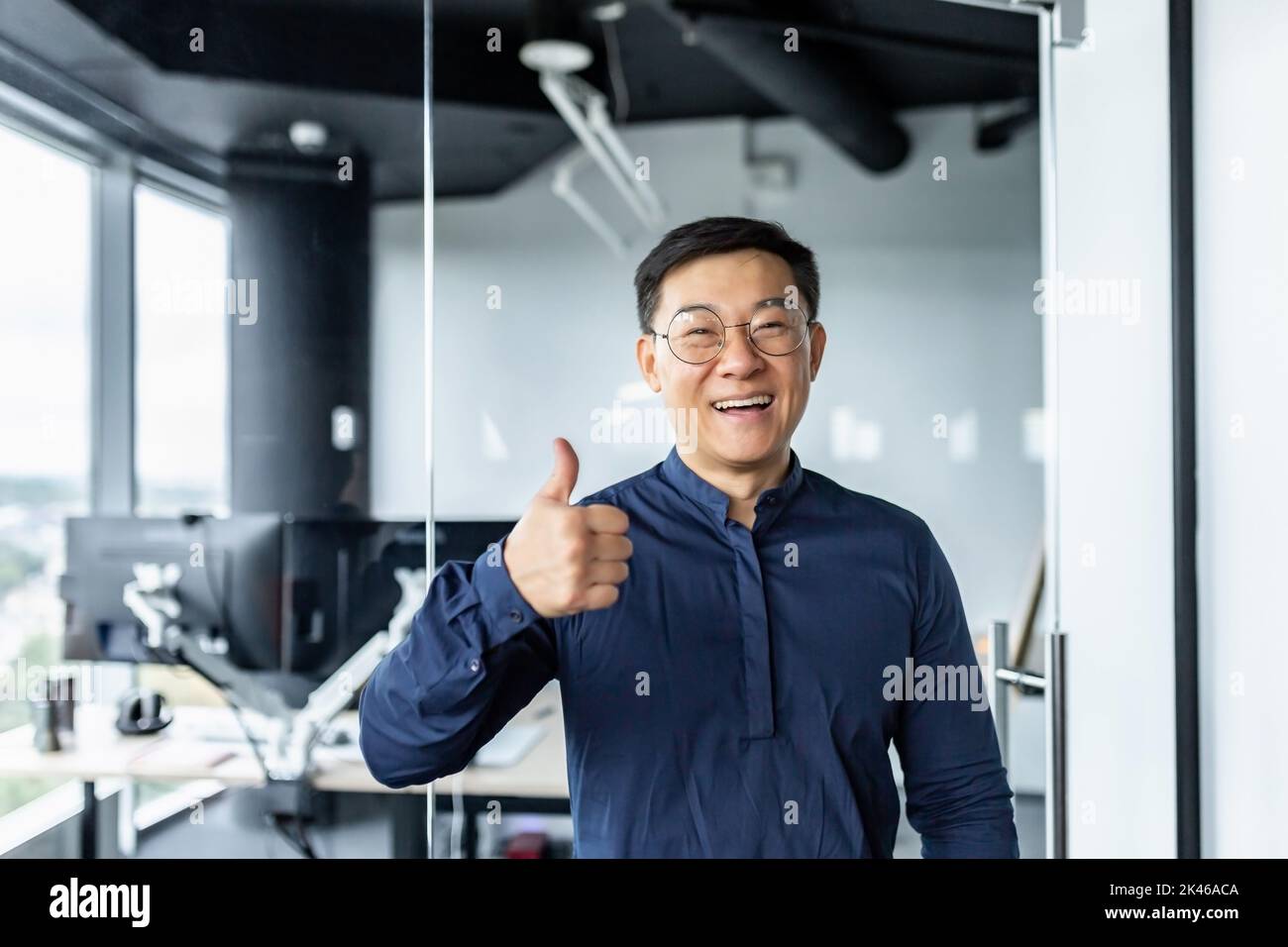 Portrait of successful asian businessman, man working in modern office ...