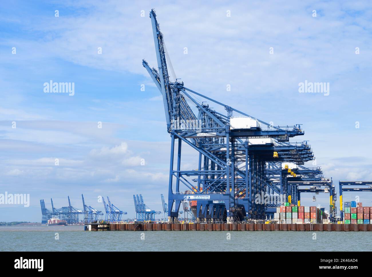 Shipping containers on the dock at Felixstowe Port with cranes at the ...