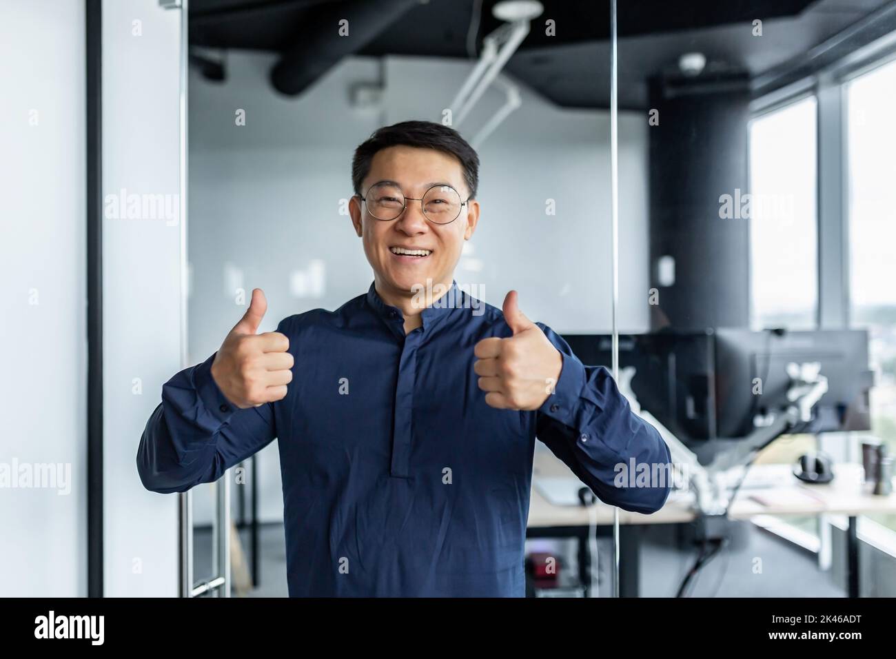 Portrait of successful asian businessman, man working in modern office ...