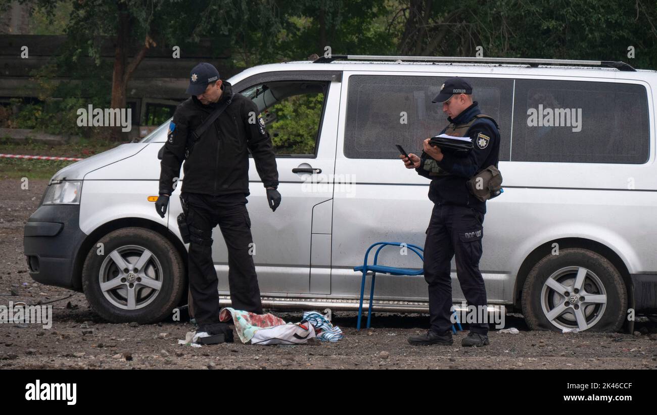 Police investigate a Russian missile strike on a civilian convoy Stock ...