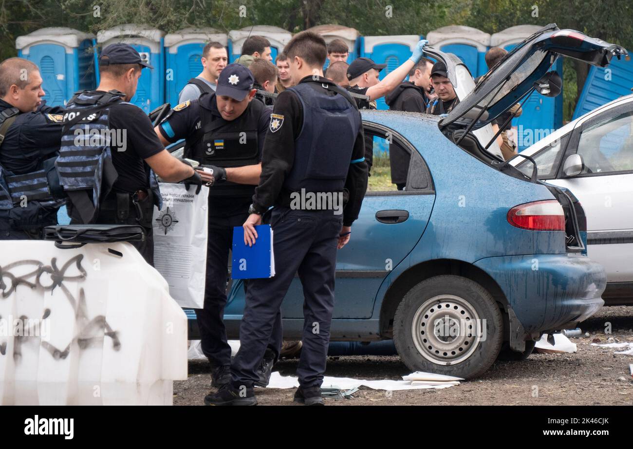 Police investigate a Russian missile strike on a civilian convoy Stock ...