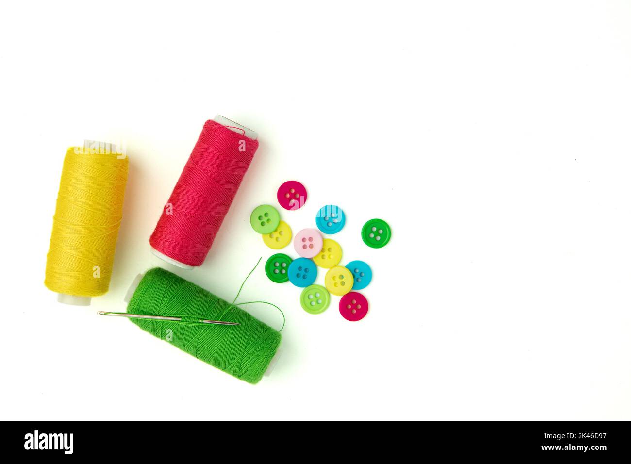 composition with threads and buttons on white background, theme sewing ...