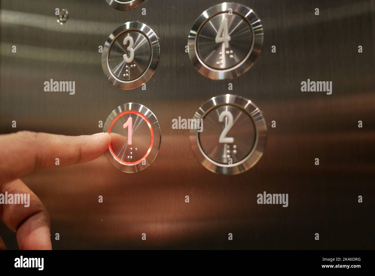 The man push lift button down Stock Photo - Alamy