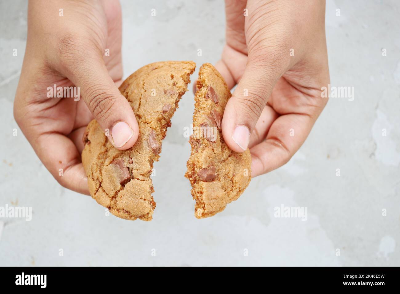 person hand eating sweet cookies Stock Photo - Alamy