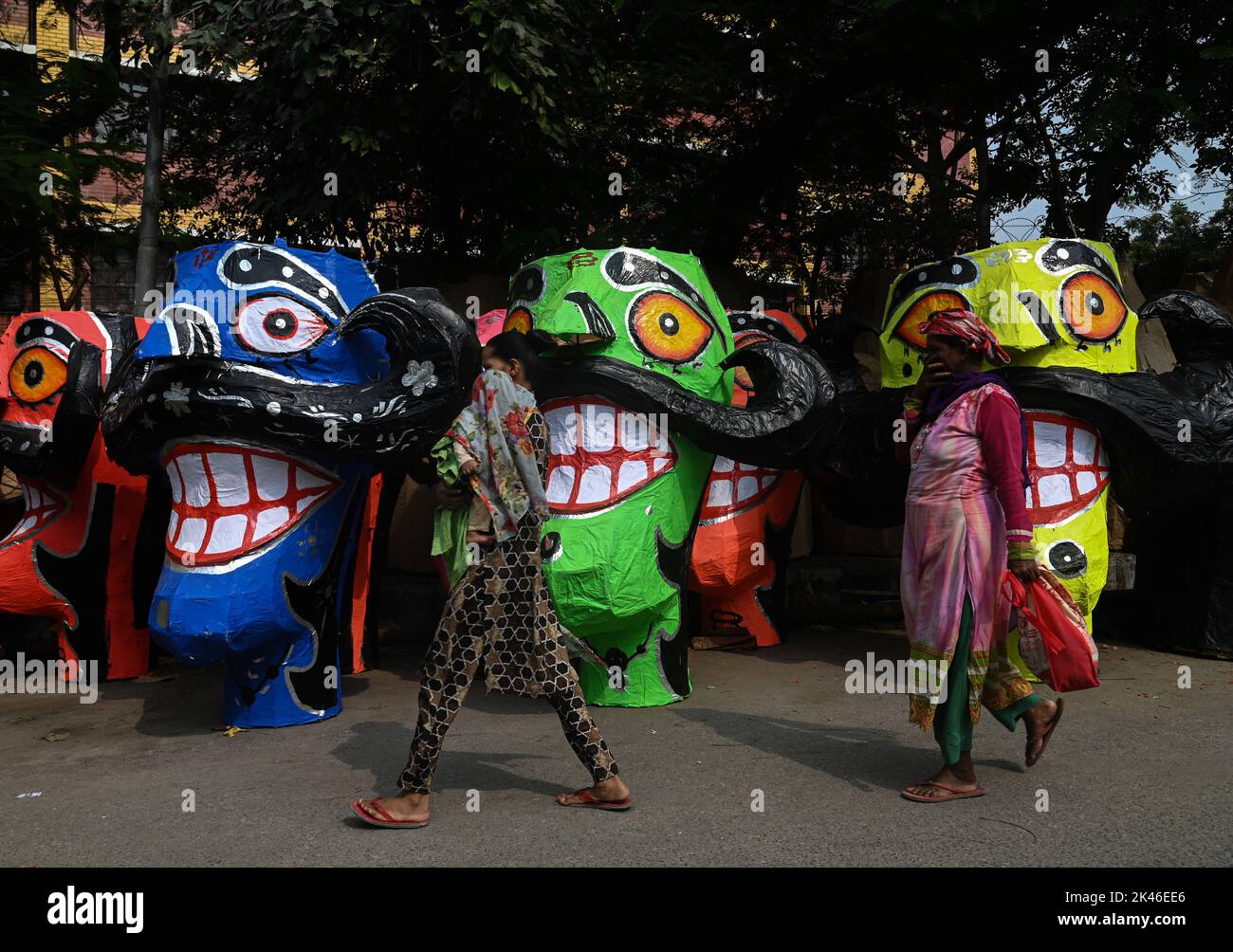 New Delhi, Delhi, India. 30th Sep, 2022. Women walk past the effigies ...