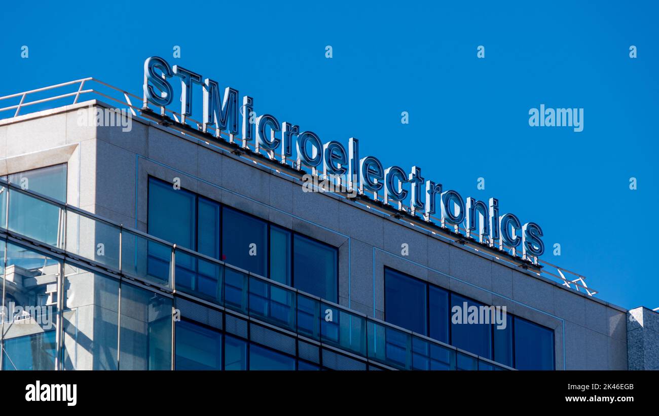 Sign on top of a building with the name of STMicroelectronics written ...