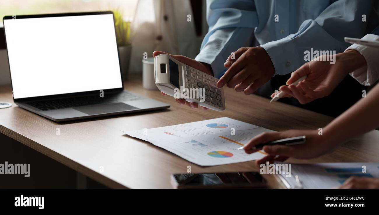 Business and partnership discussing using calculator to review balance ...