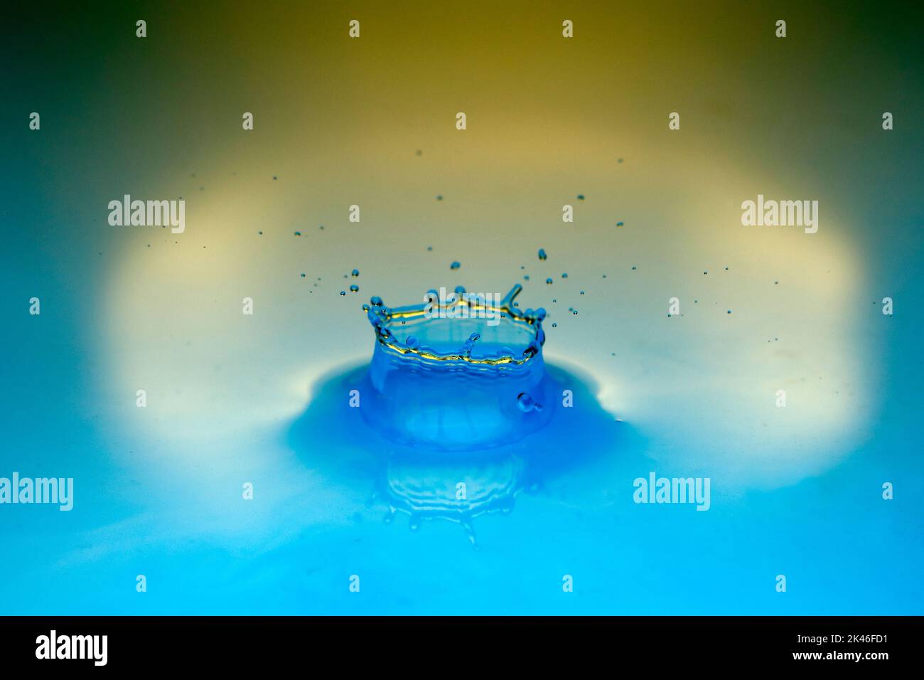 A misterious splashing crown in a coloured liquid Stock Photo - Alamy