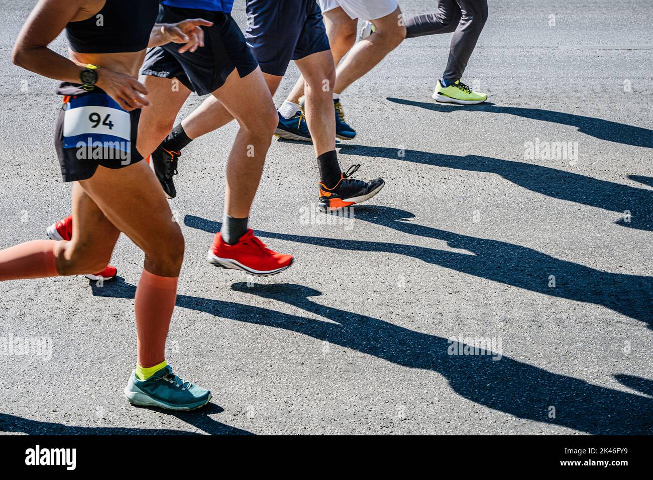 legs group runners run marathon race on road Stock Photo - Alamy