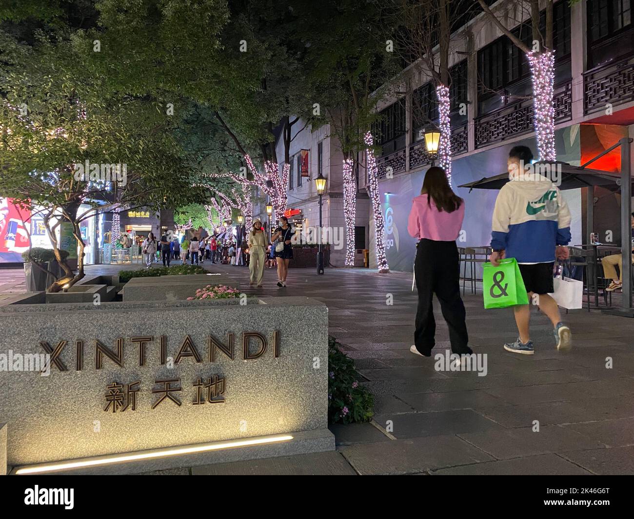 Young consumers walk past commercial compound Xintiandi on a Tuesday night. September 20, 2022 ...