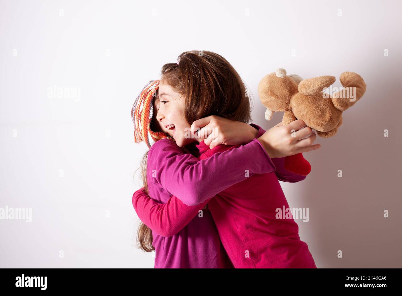 Happy and healthy young little girls hugging and smiling. Best friend ...