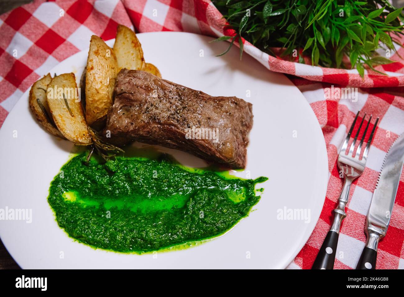 Picanha steak with green chimichurri sauce and country-style baked ...