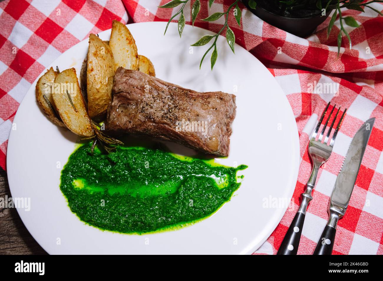 Picanha steak with green chimichurri sauce and country-style baked ...
