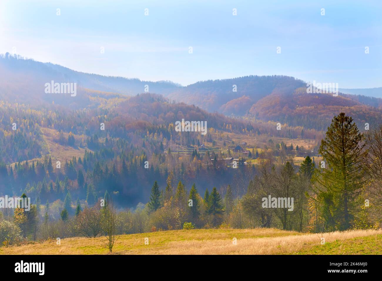 Autumn small village in a valley and mountains in a blue haze Stock ...