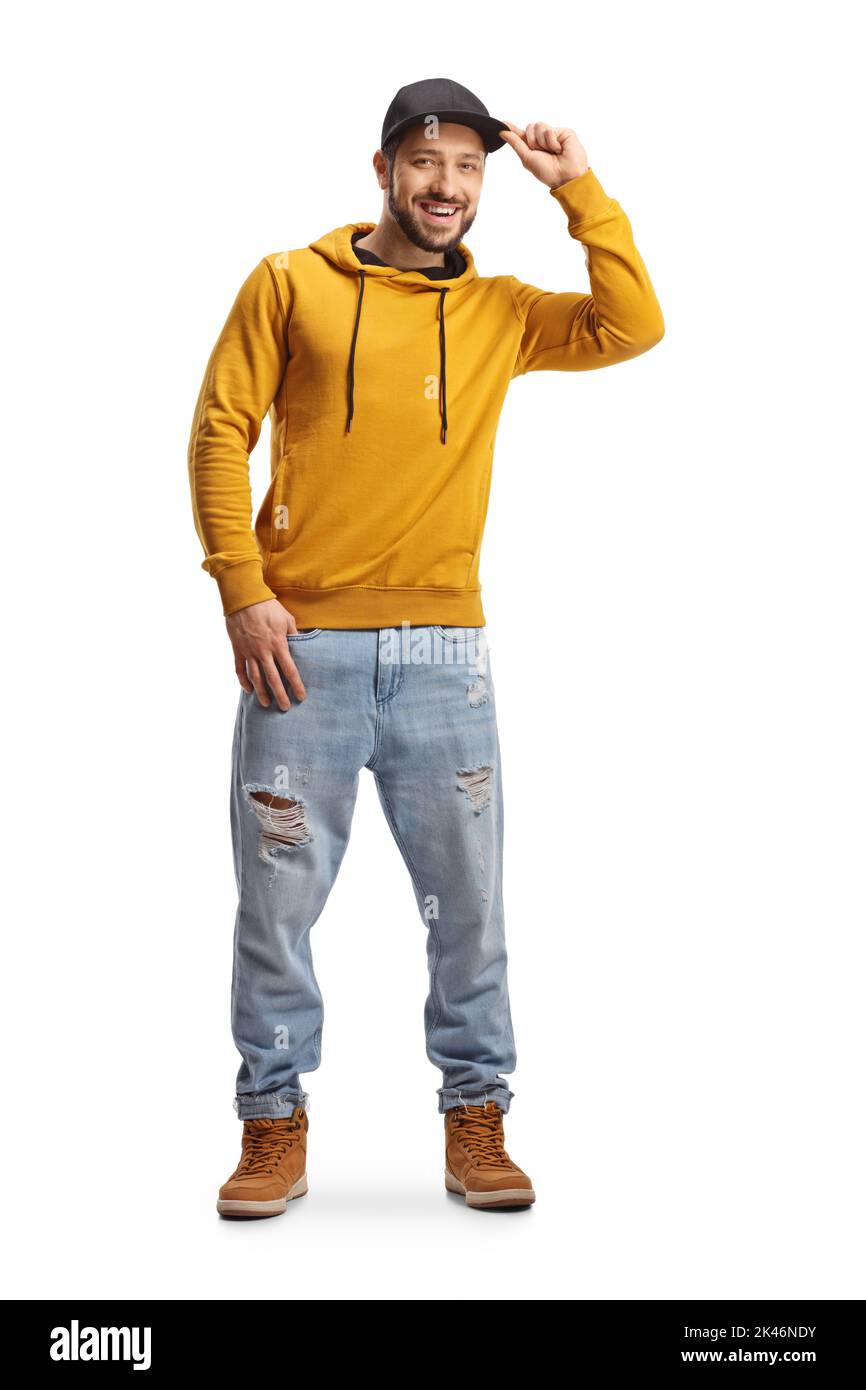 Smiling young man in a yellow sweathsirt greeting with cap isolated on ...