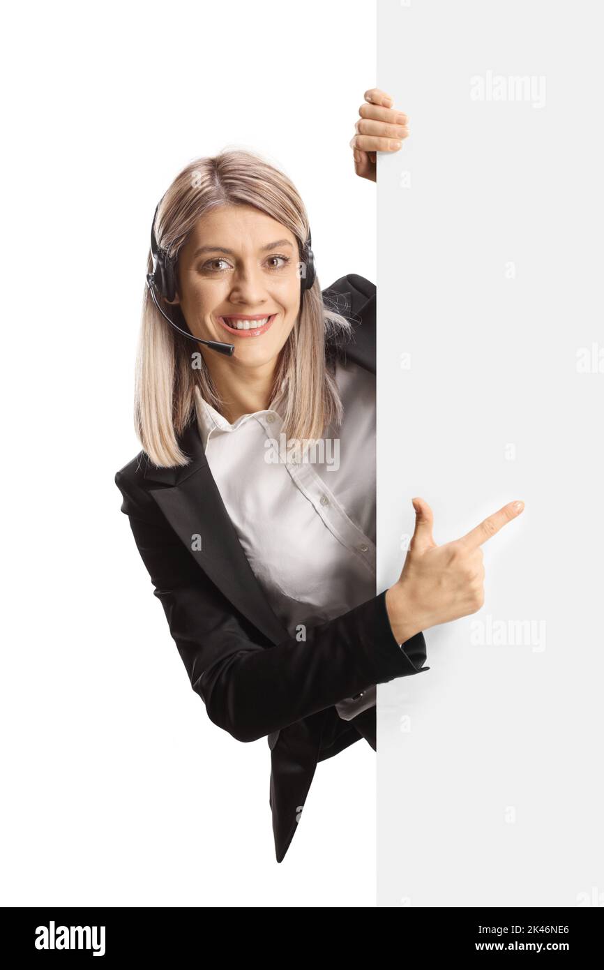 Young female call operator standing behind a blank white board and ...