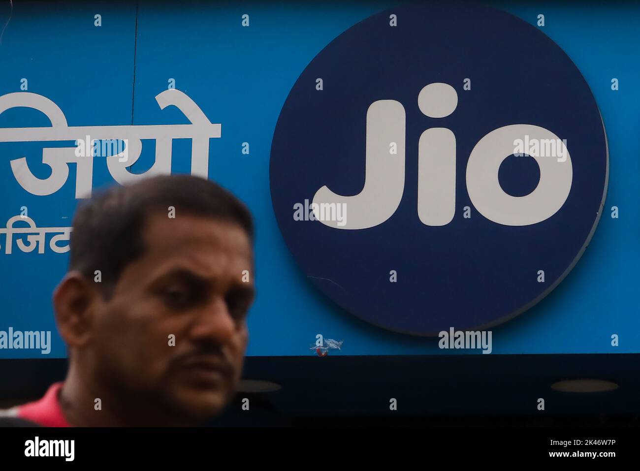 Mumbai, Maharashtra, India. 29th Sep, 2022. A man walks past a logo of ...
