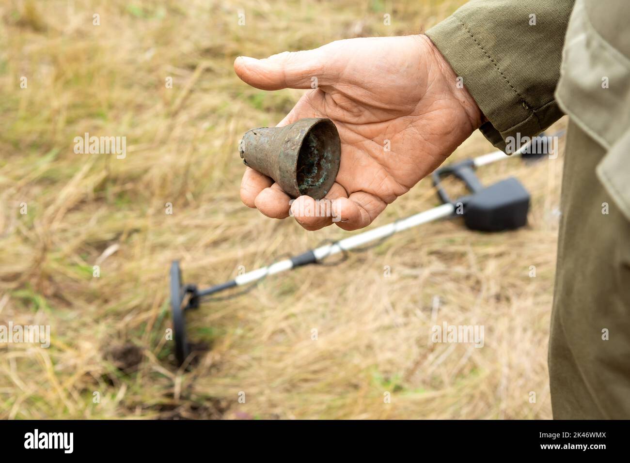 Man with electronic metal detector device working on outdoors. Close-up ...