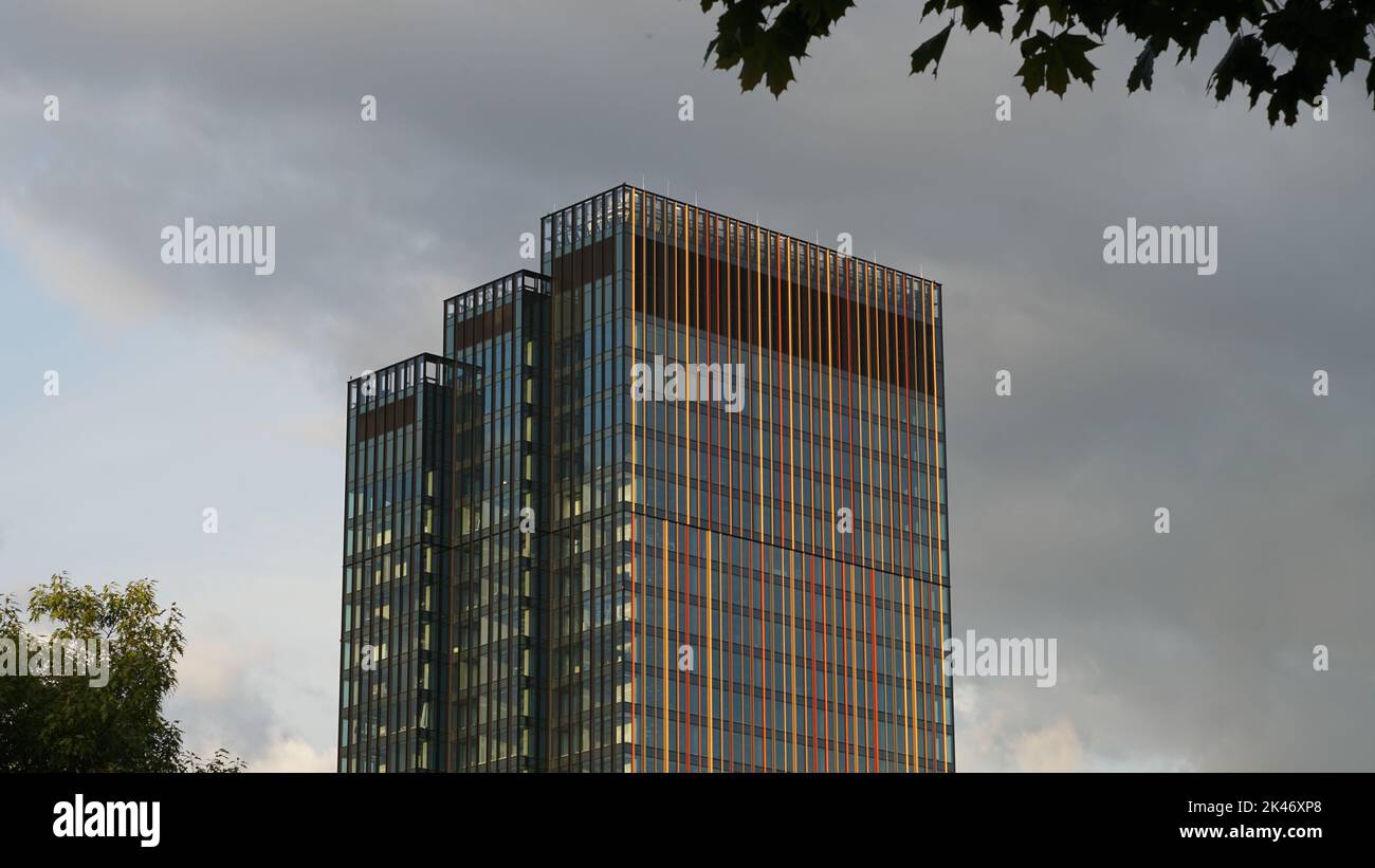 Modern glass city building isolated on cloudy sky Stock Photo - Alamy