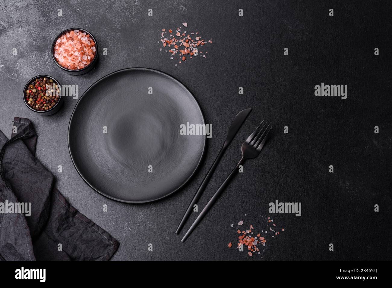 Black cutlery on a concrete dark table. Dining table preparation Stock ...