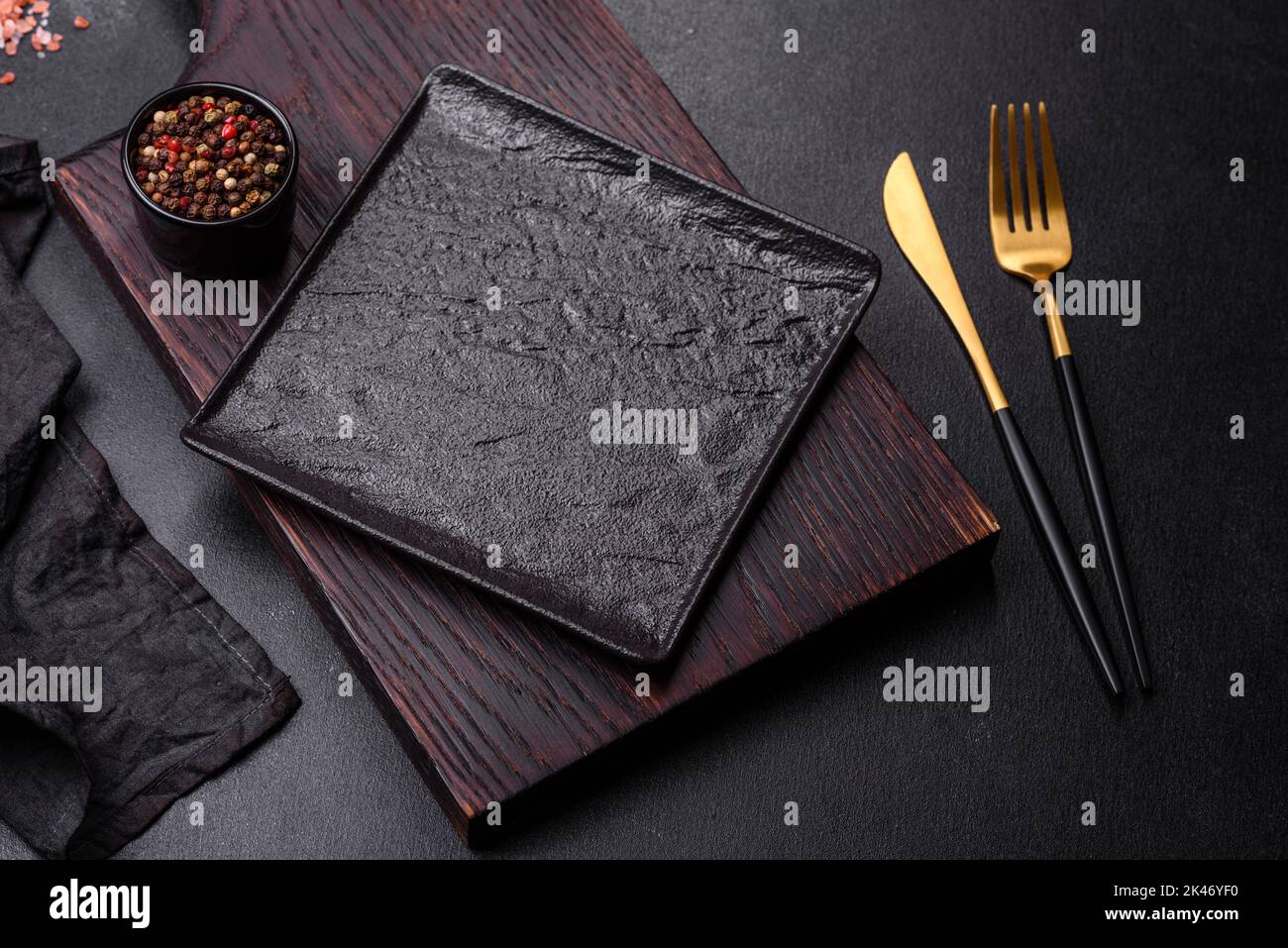 Black cutlery on a concrete dark table. Dining table preparation Stock ...
