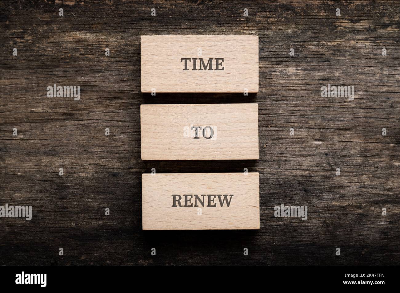 Time to renew sign spelled on three stacked wooden blocks placed over ...