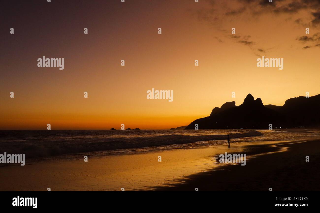 Rio de Janeiro, RJ, Brazil, 2022 - A person in silhouette on Ipanema ...