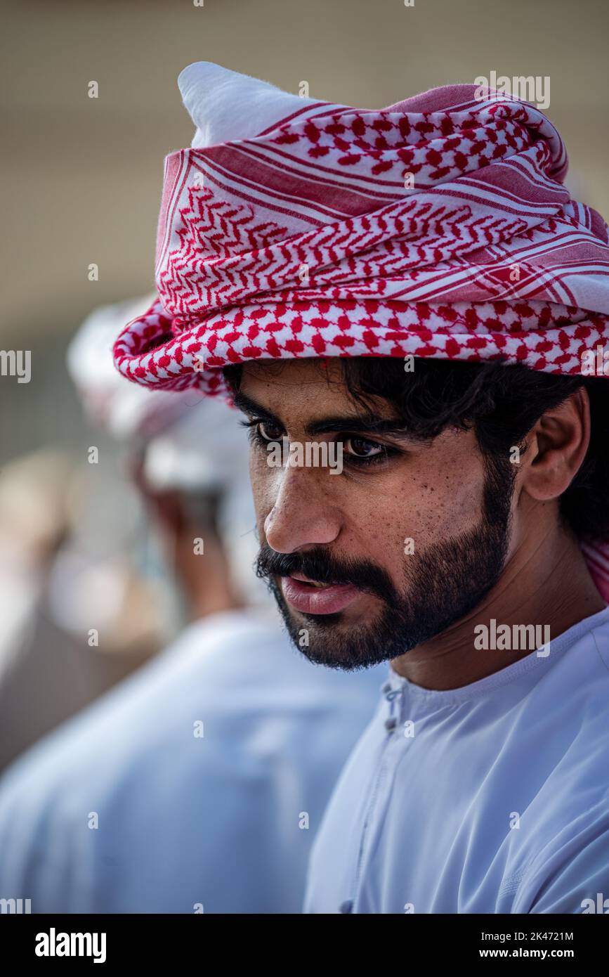 Portrait of a young man with turban at the friday morning cattle market ...